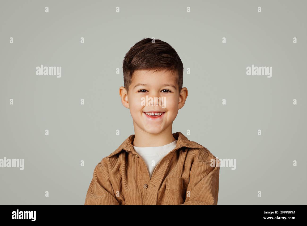 Cheerful cute european little child 6 years old in shirt looking at ...