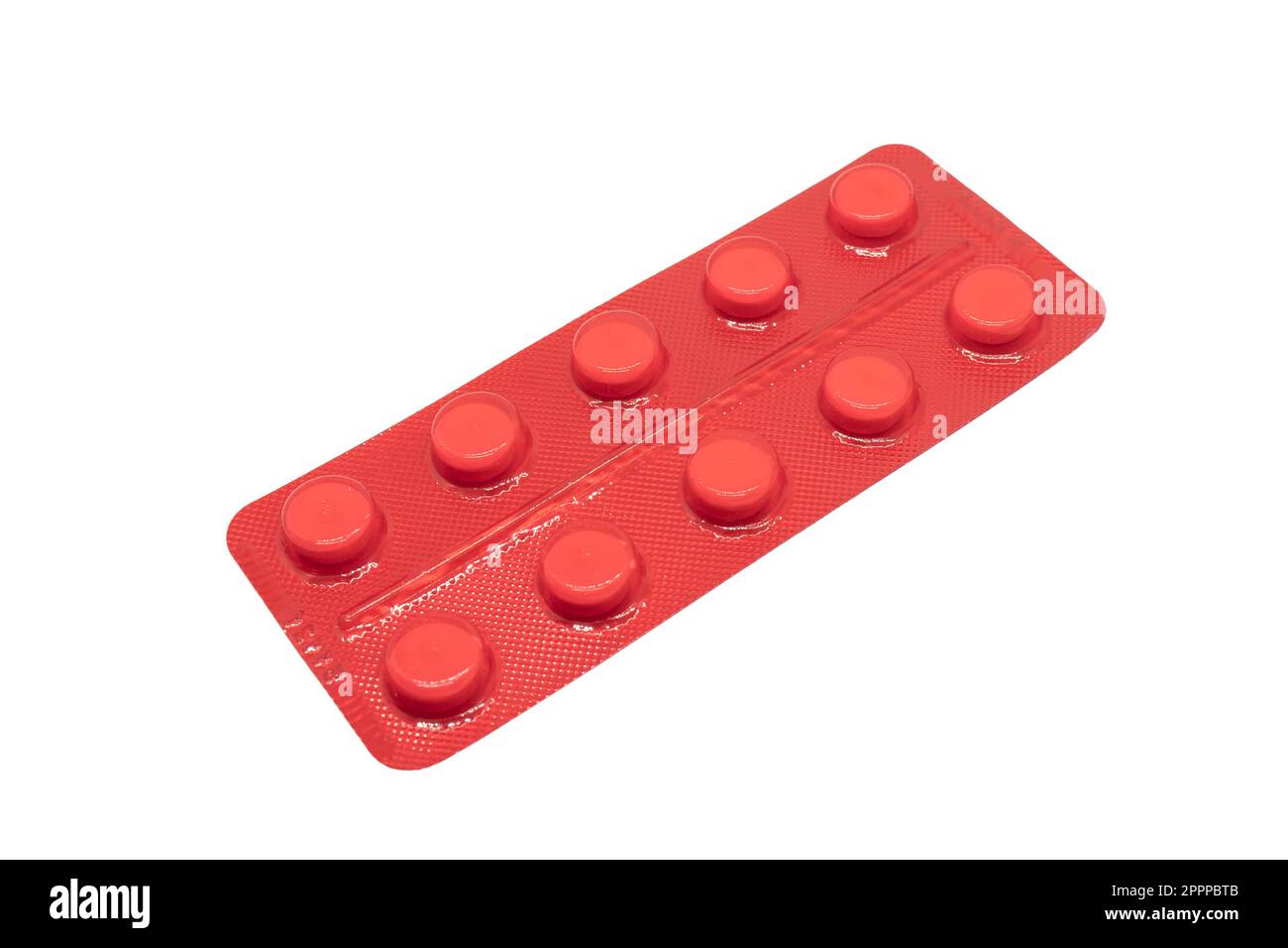 Macro shot pile of white tablets pill in red blister packaging isolated ...