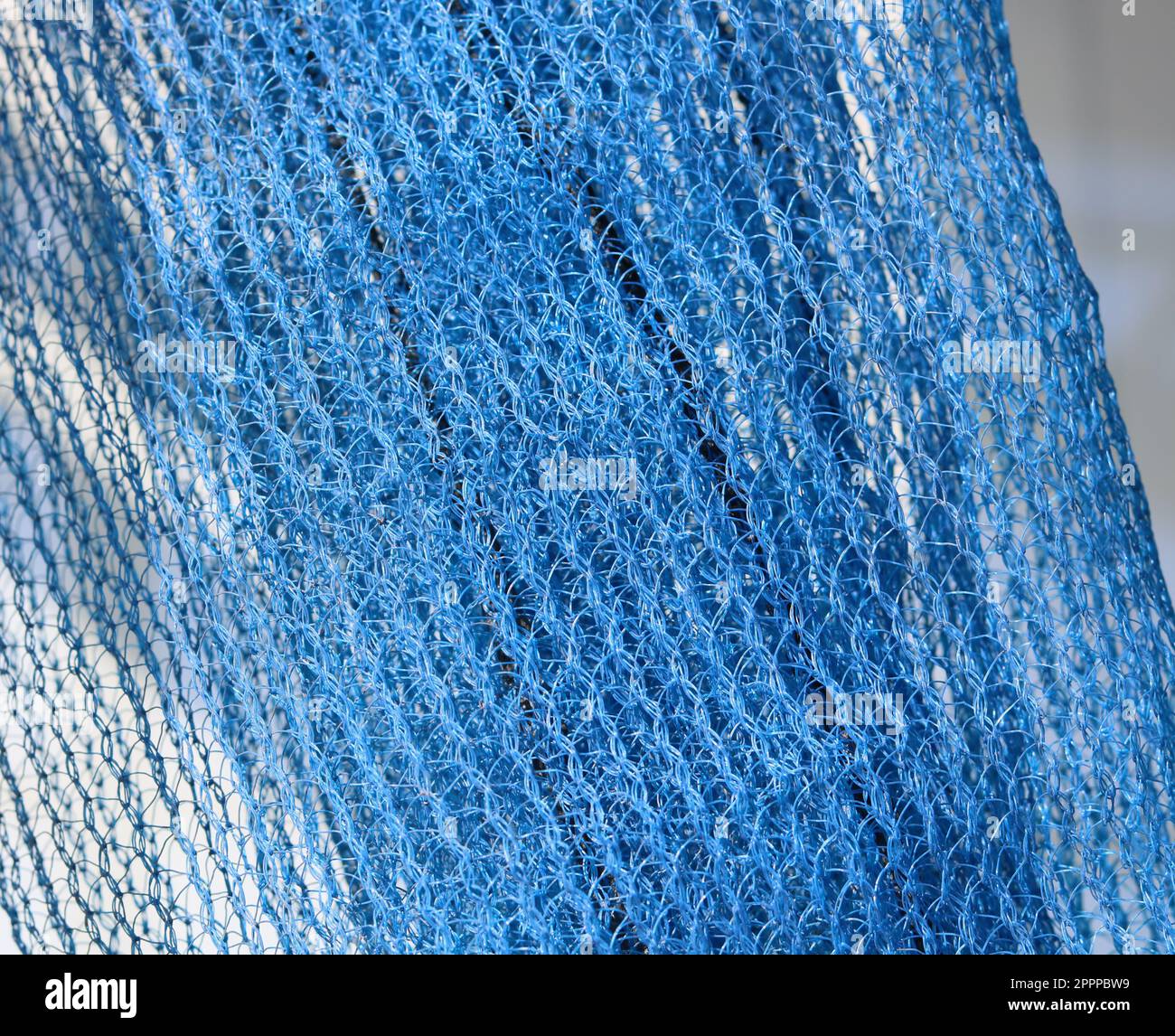 Full frame mid blue nylon netting textured background or wallpaper ...