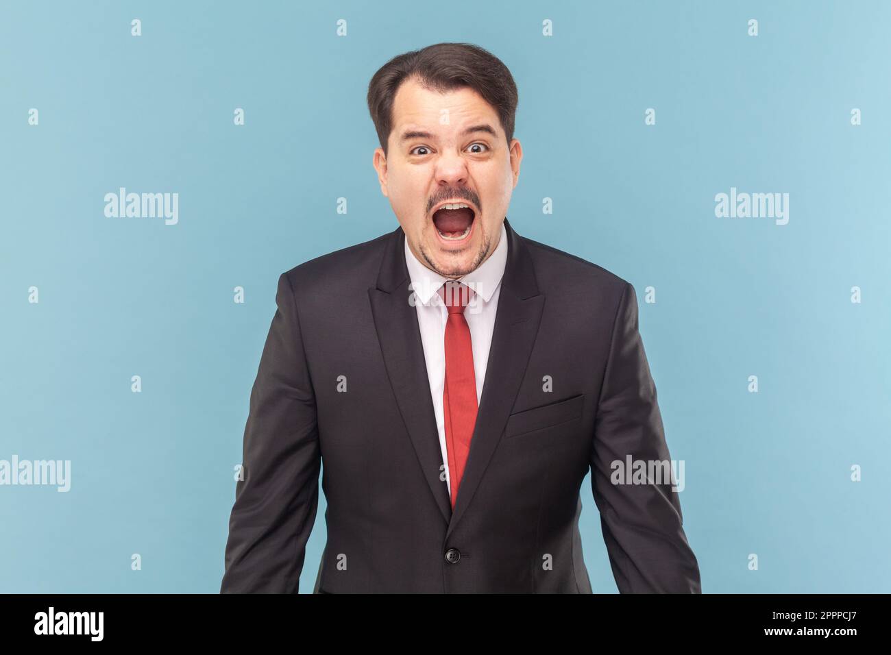 Portrait of angry furious man with mustache standing standing and ...