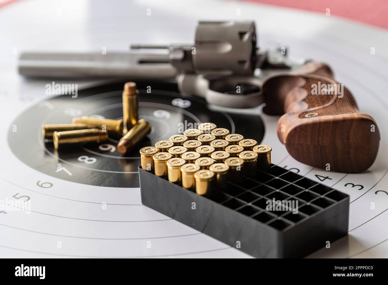 Revolver gun and bullets on background of the target, close up Stock ...