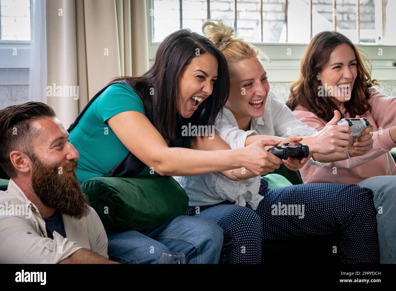 Group of friends having fun and laughing while playing video games. Top ...