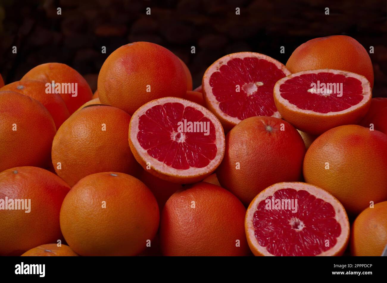 Group of fresh ripe pink grapefruit whole and cut, can be used as ...