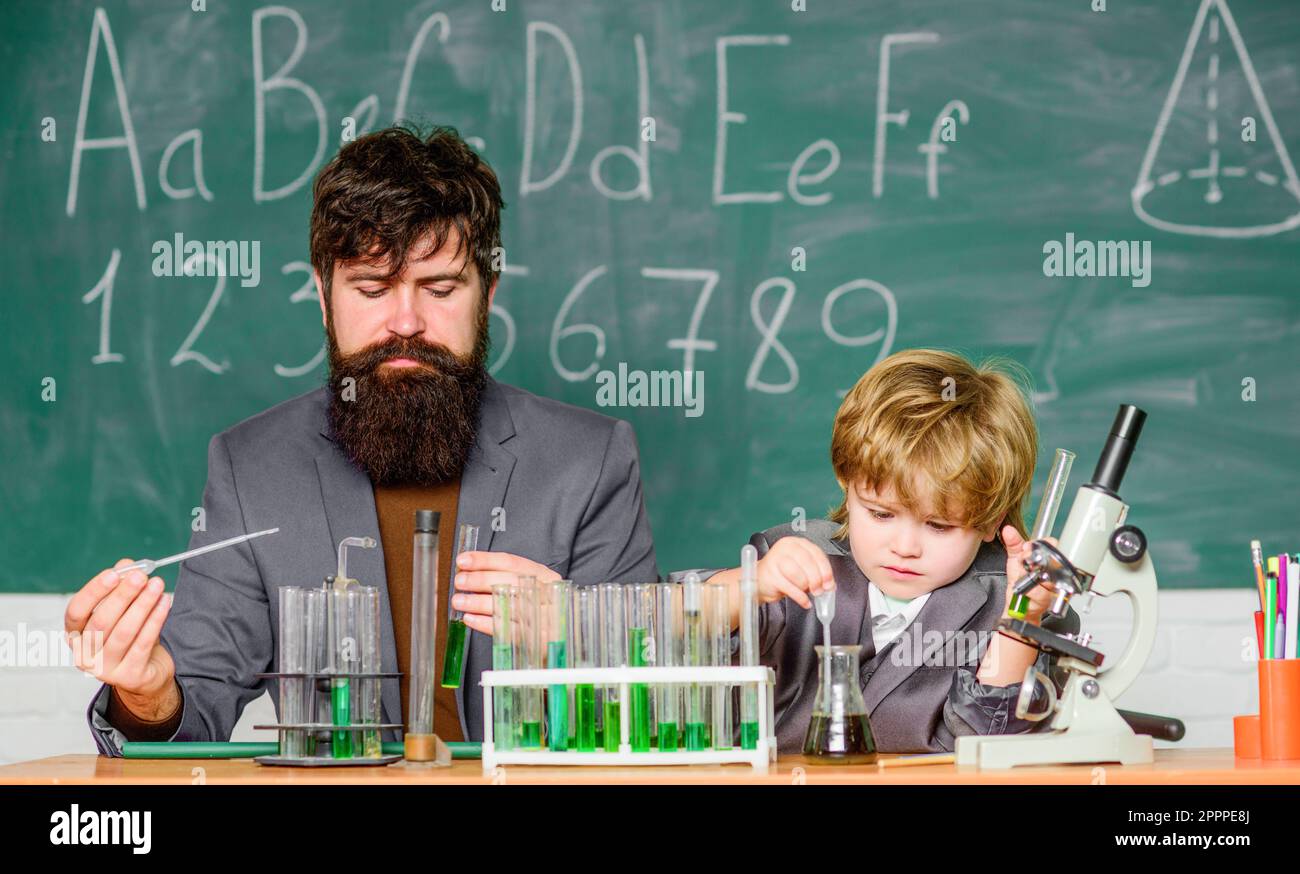 learning chemistry in school lab. Back to school. father and son at ...