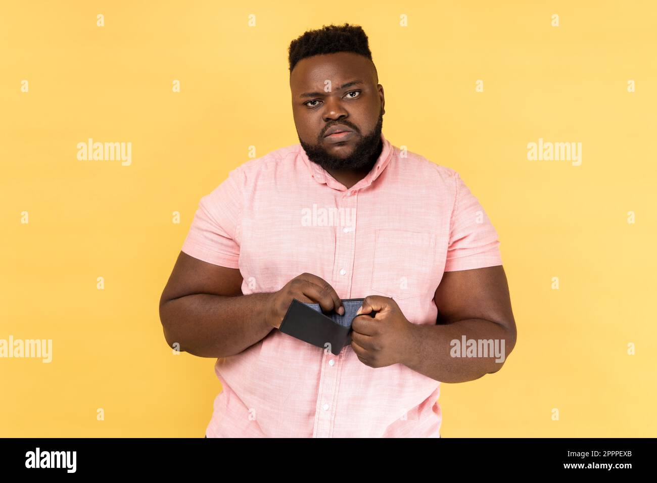 Portrait of sad poor depressed bearded man wearing pink shirt standing ...