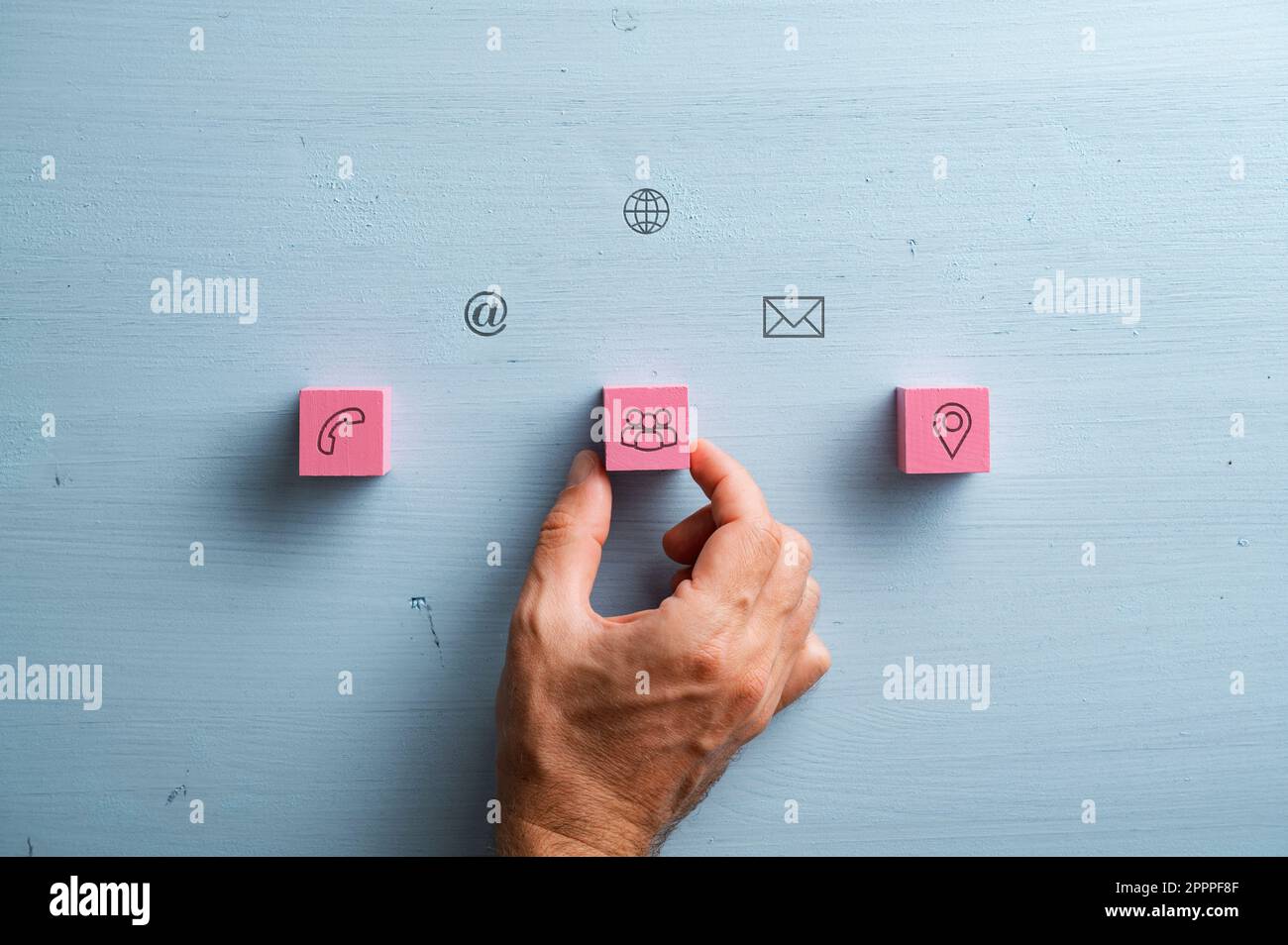 Contact and communication icons and symbols printed on pink wooden ...