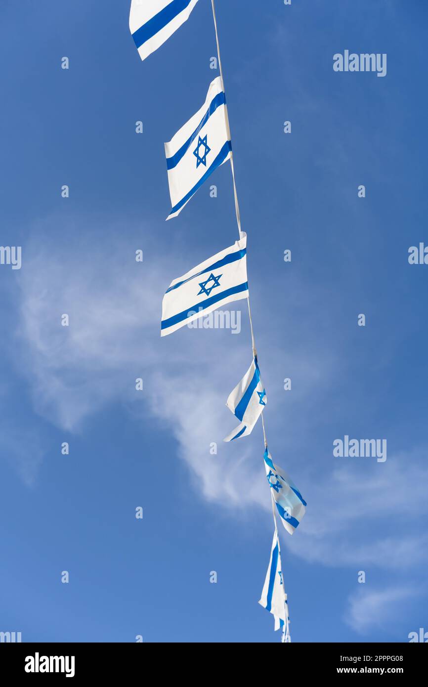 Israeli blue and white flag bunting fluttering against a backdrop of ...