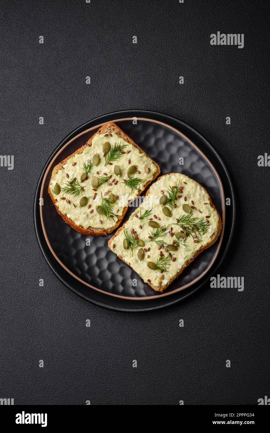 Grilled toast with avocado paste, eggs, cream cheese, salt, spices and ...