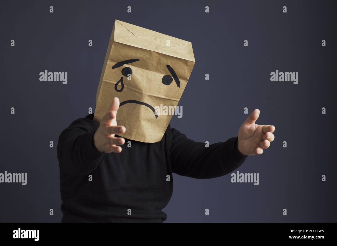 A sad man in a black turtleneck with a bag on his head, with a drawn ...