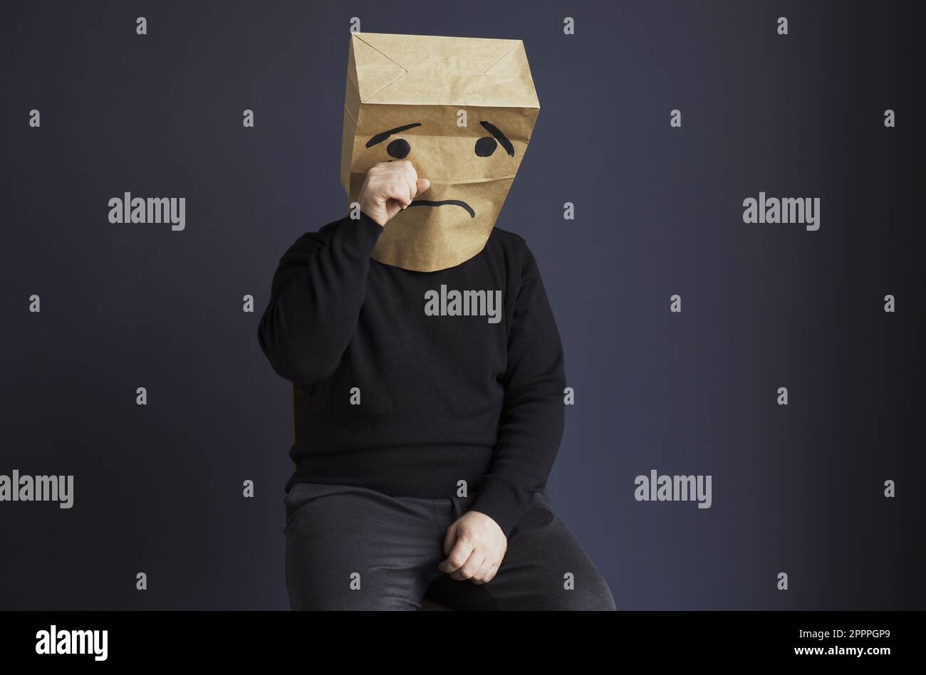 A sad man in a black turtleneck with a bag on his head, with a drawn ...