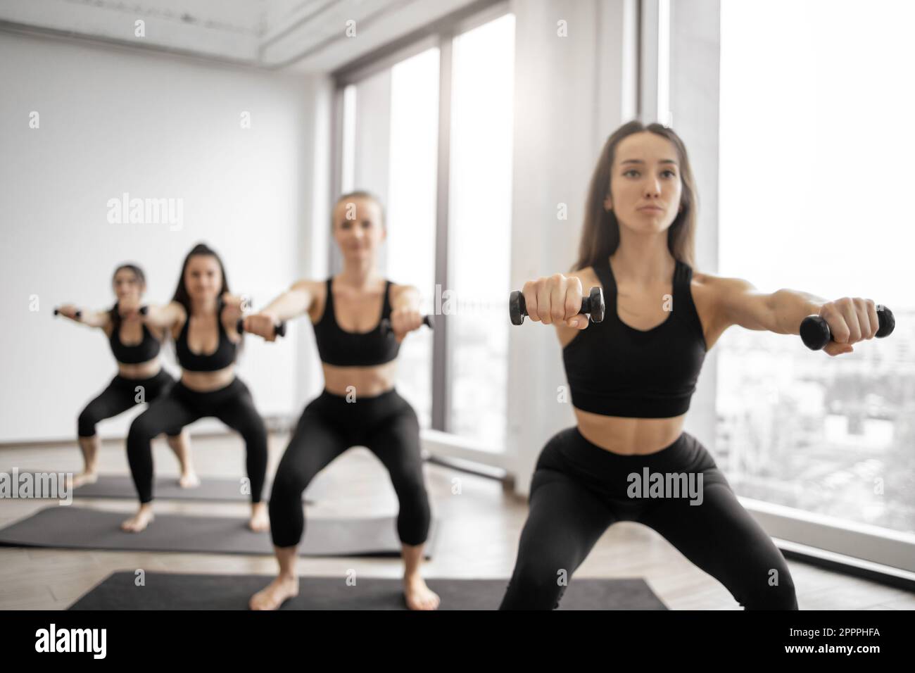 Woman performing dumbbell squat hi-res stock photography and images - Alamy