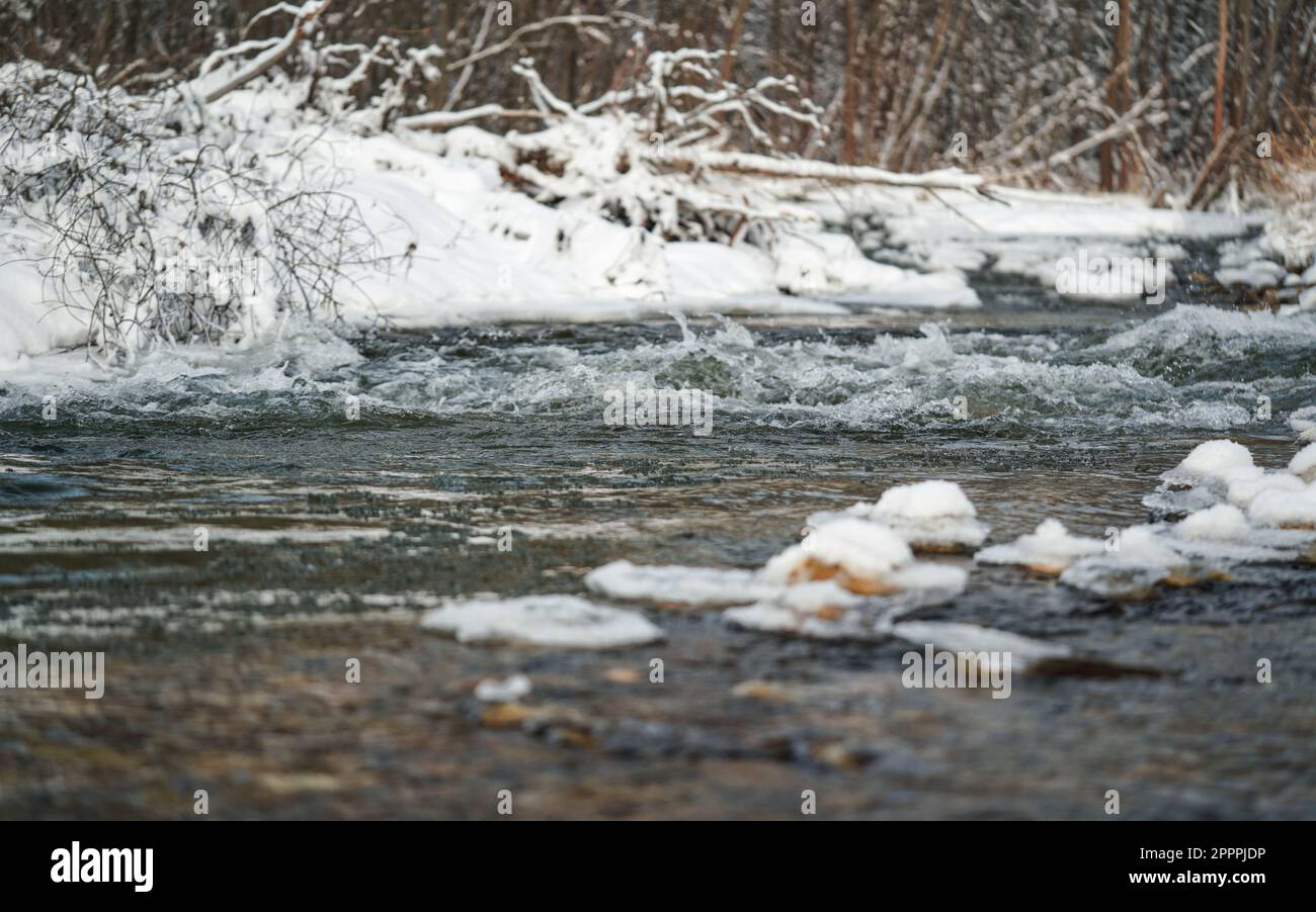 Winter river surface with snow crystals and ice floating on water Stock ...