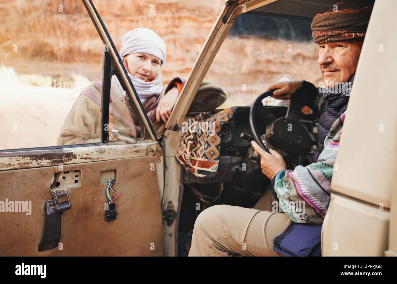 Man in traditional Bedouin coat - bisht - and headscarf, posing behind ...