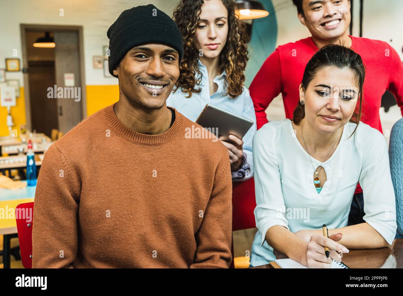 Mixed group of trendy young students studying in a university study ...