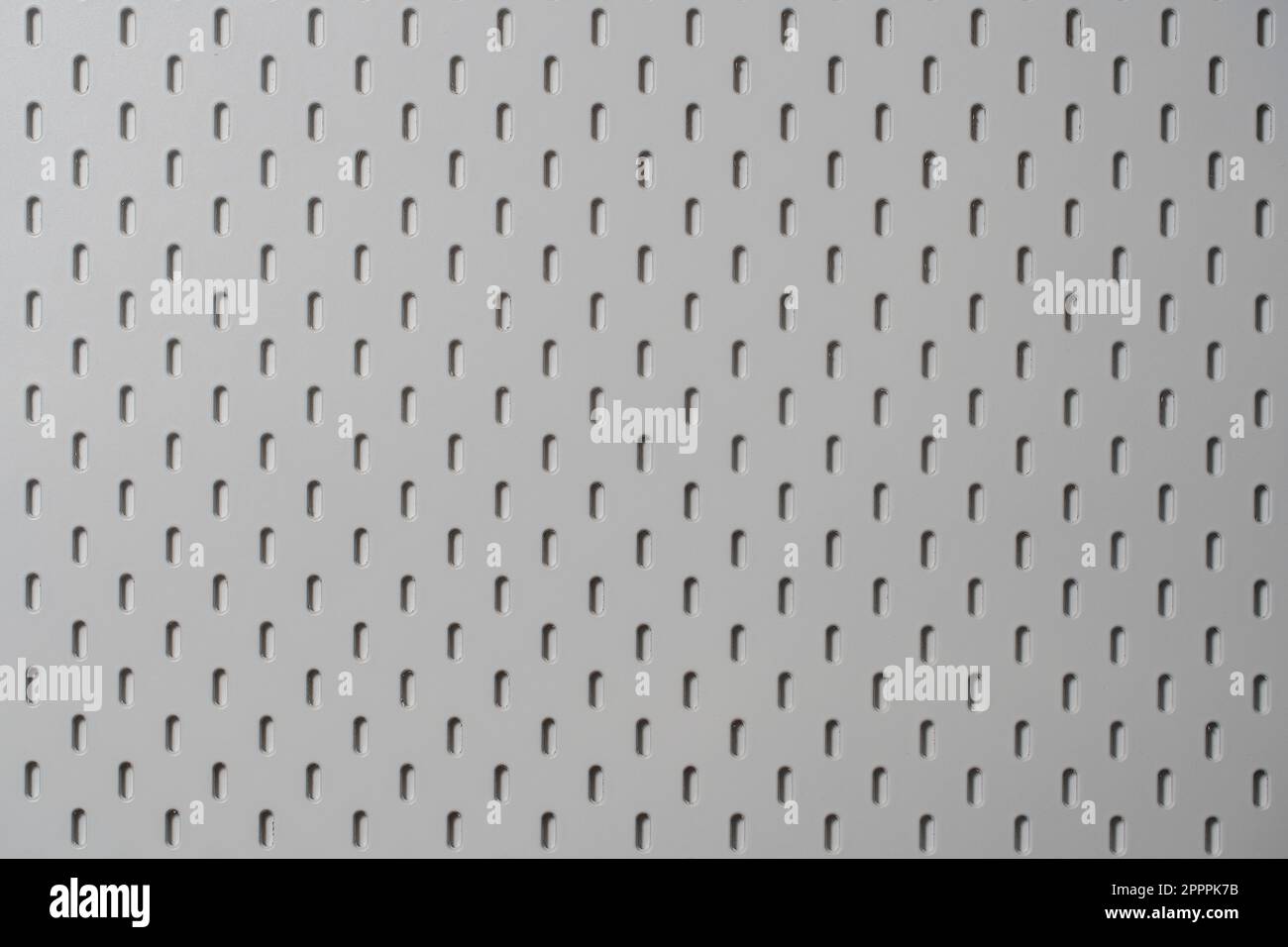 Perforated white plastic panel for background or texture. Surface with ...