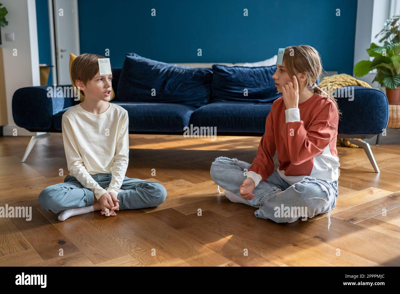 Children boy and girl siblings playing Who Am I guessing game while ...