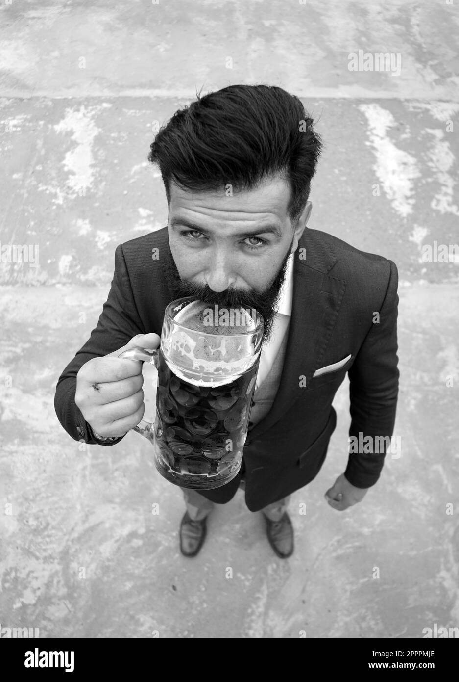 Full length, wide angle. Funny man drinking beer from a glass mug Stock ...