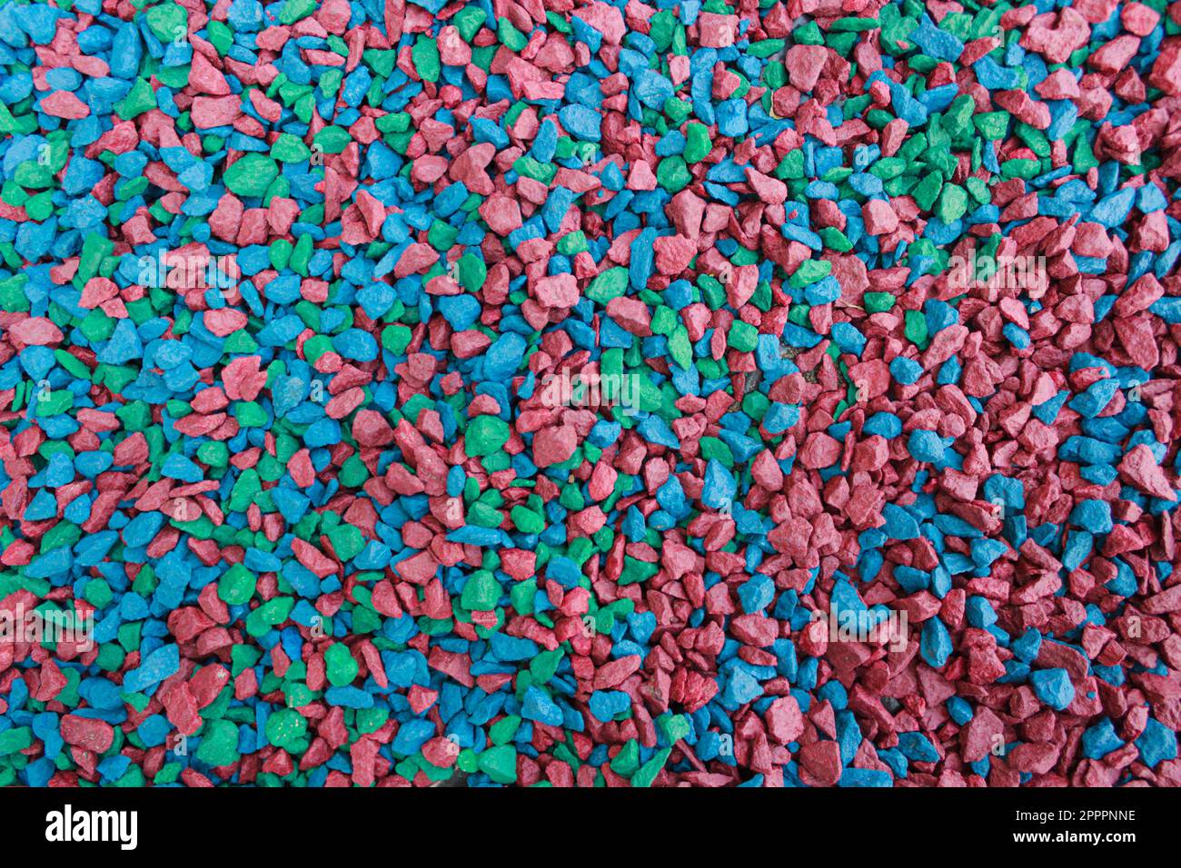 Small pebbles of bright color, background of blue, pink and green ...