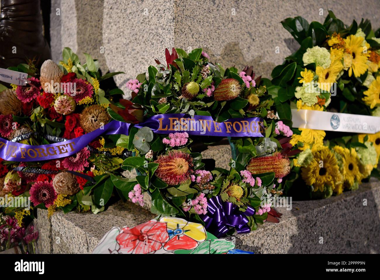 Wreaths are places around the Cenotaph during the Anzac Day Dawn ...