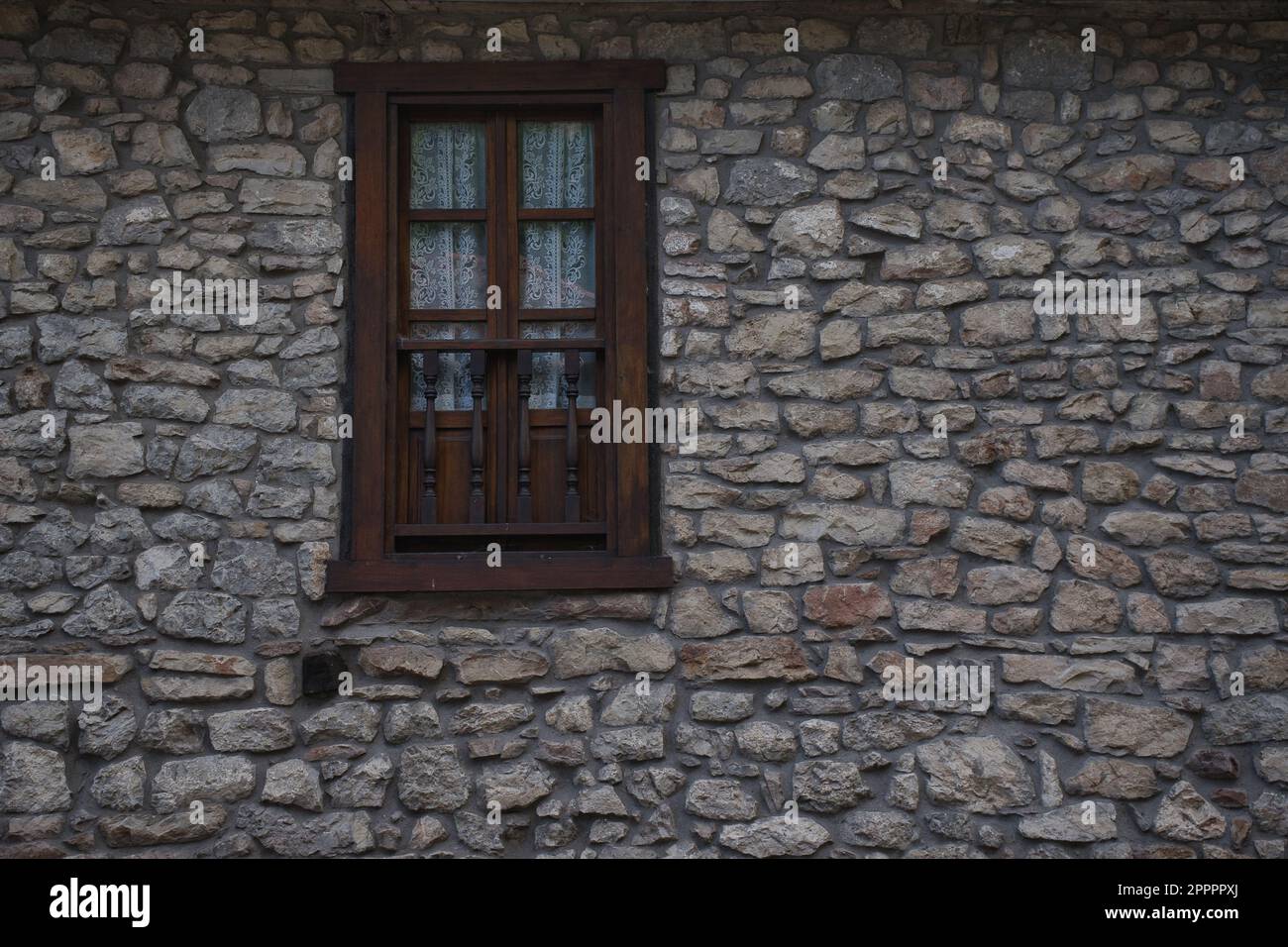 Natural stone facade with wooden window detail. Rural house in the ...
