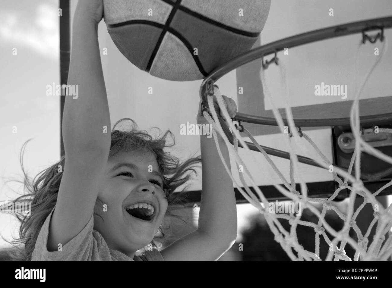 Little caucasian sports kid playing basketball holding ball with happy ...