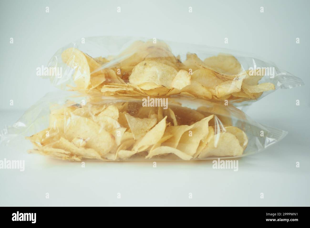 tasty potato chips in a packet on white background Stock Photo - Alamy