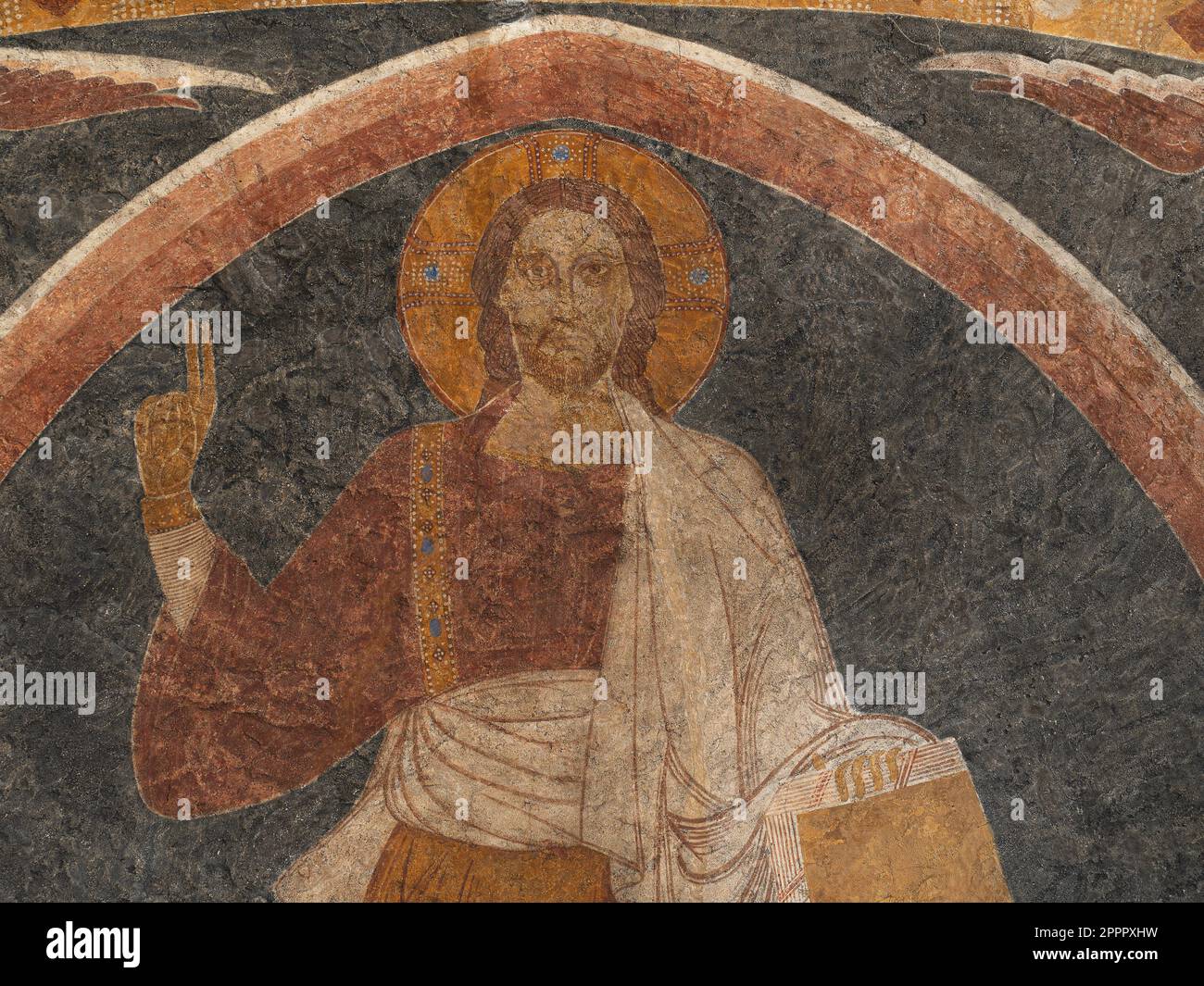 Christ pantocrator blessing with his raised hand and holds a book in ...