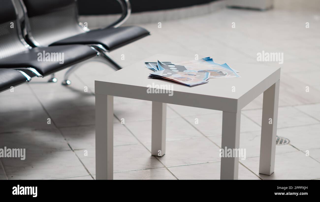 Empty hospital reception in lobby with medical leaflets on table ...