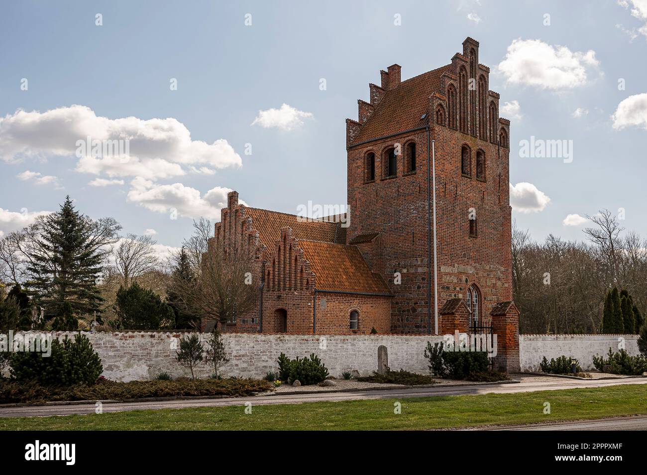 a danish medieval brick church behind a white wall, Sæby, Zealand ...