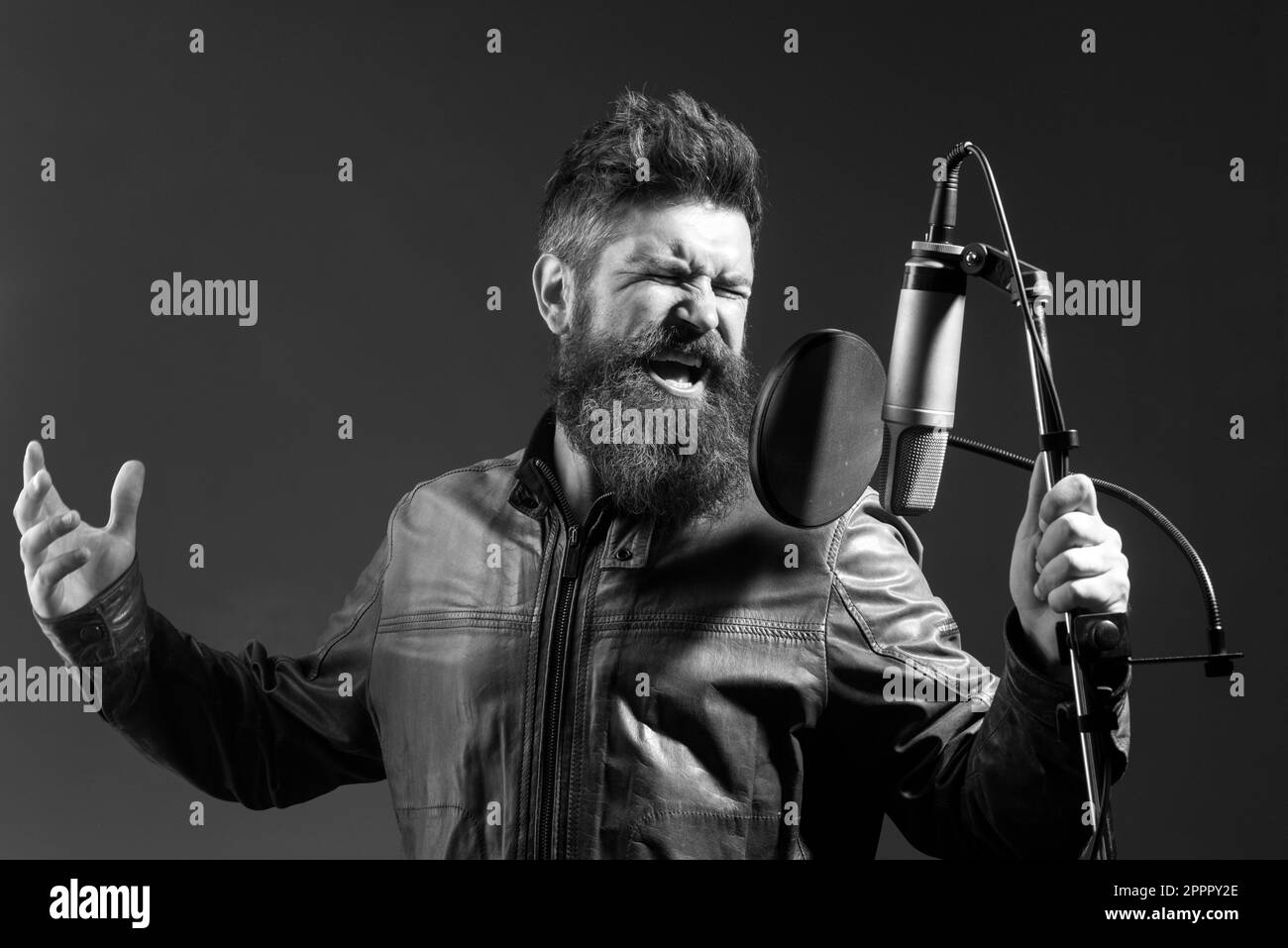 Singer singing rock. Expressive singer with microphone. Sound producer ...