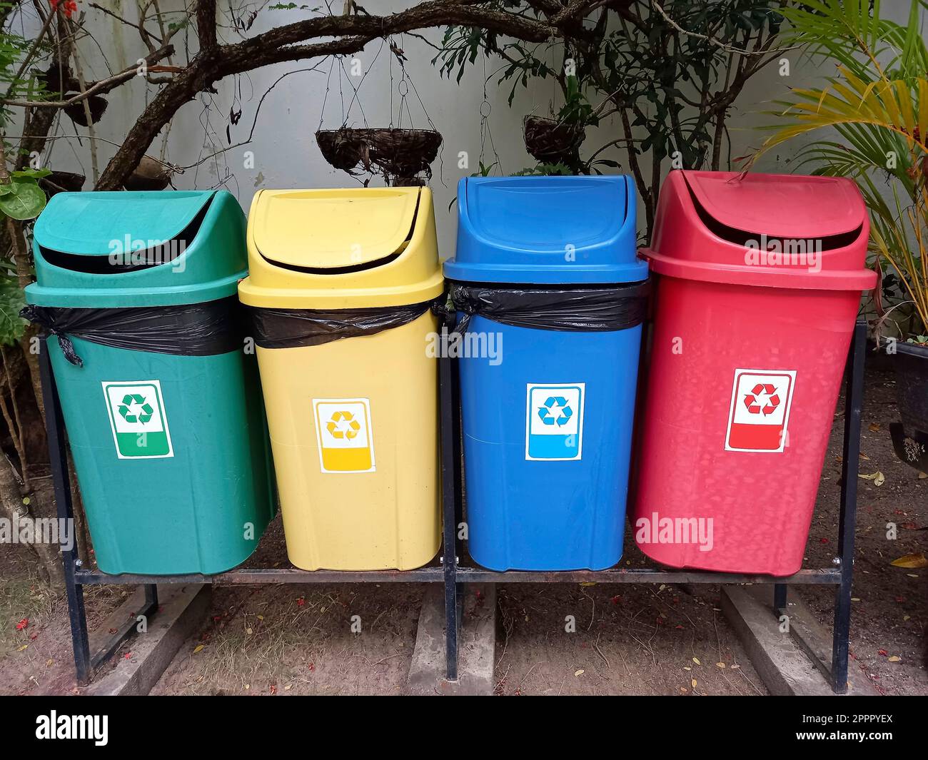 several plastic bins with different colors for garbage collection and ...