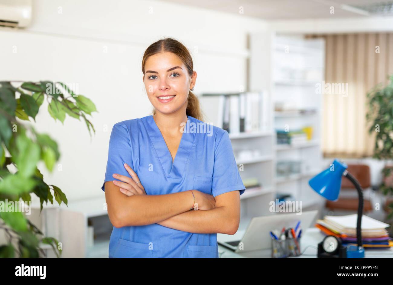 Portrait of a young female doctor standing in a resident's office Stock ...