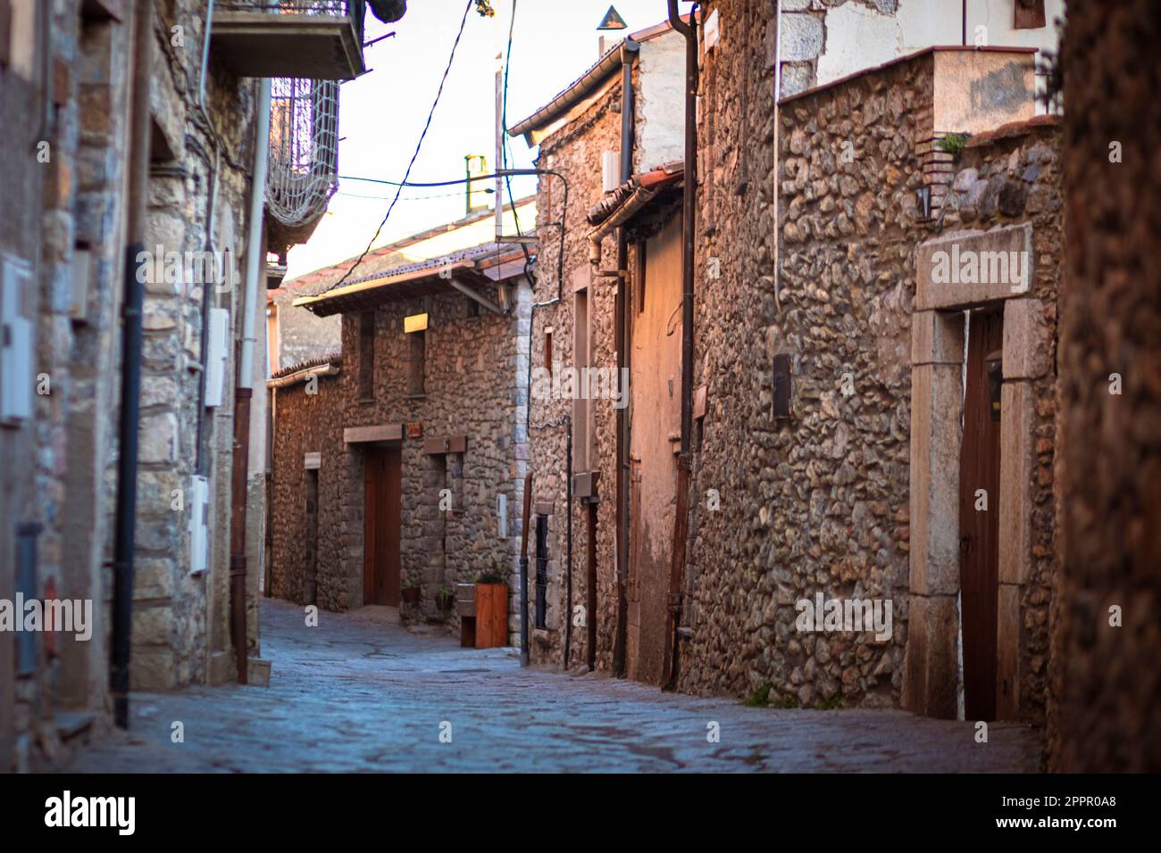 Cobble stone old rural street village town scene in an old stone house ...