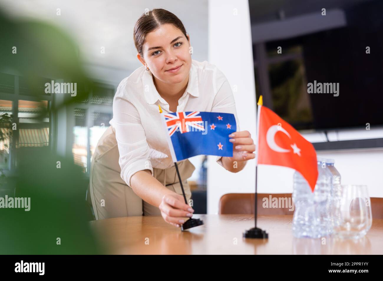 female assistant prepares conference room for Turkish and Australian ...