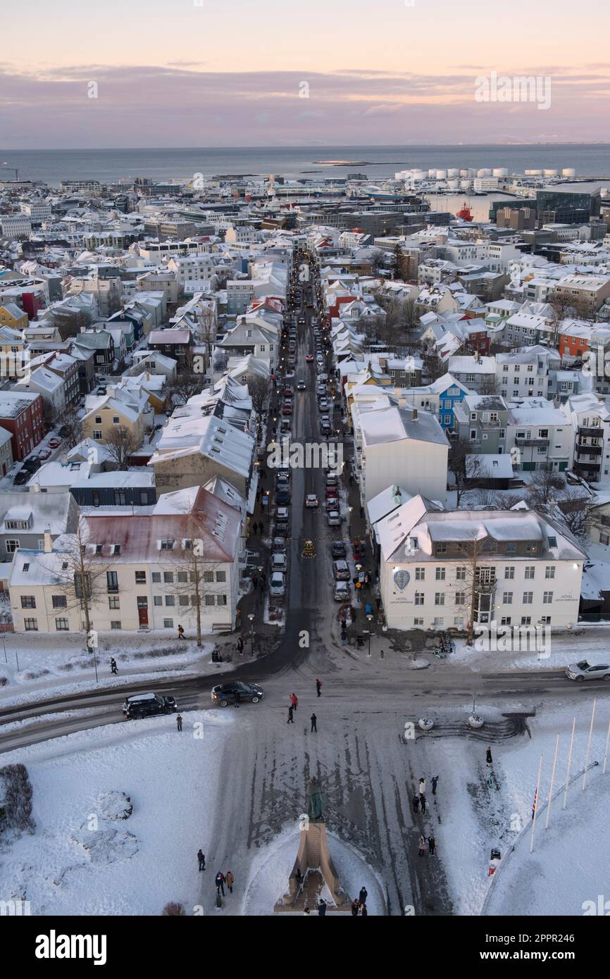 An idyllic winter scene of a cozy town with snowfall blanketing the ...