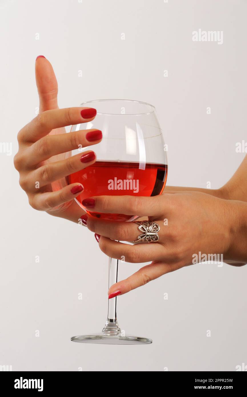 beautiful woman hand holding glass of red wine in a hand on a white ...