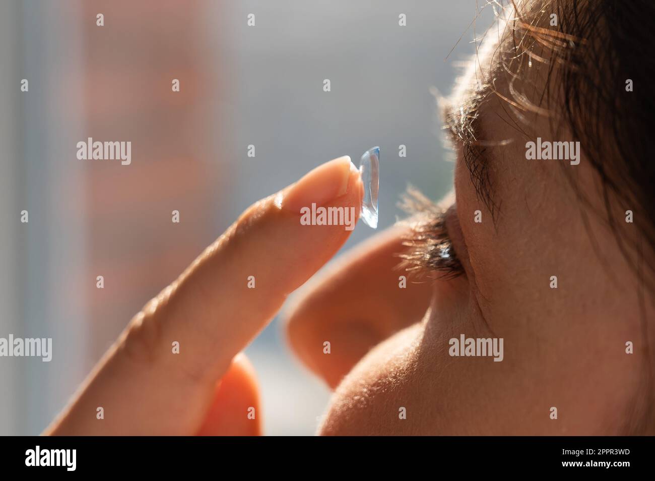 Close-up portrait caucasian woman putting on a contact lens Stock Photo ...