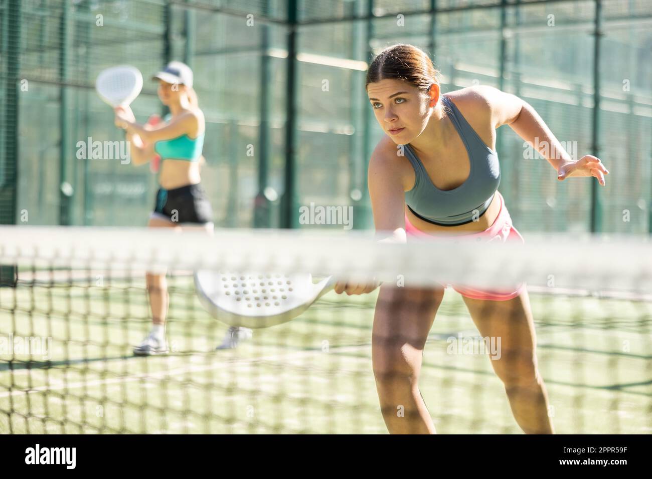Young woman playing Padel Tennis in open-air tennis court Stock Photo ...