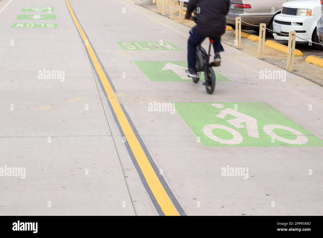 Cyclist on a bycycle path running along a beach Stock Photo - Alamy
