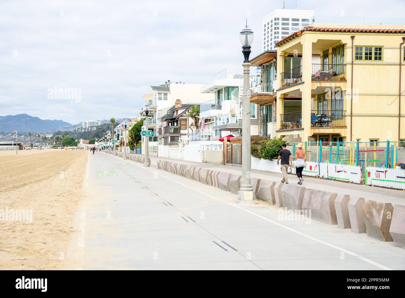 Bicycle lane and footpath lined with colourful residential buildings on ...