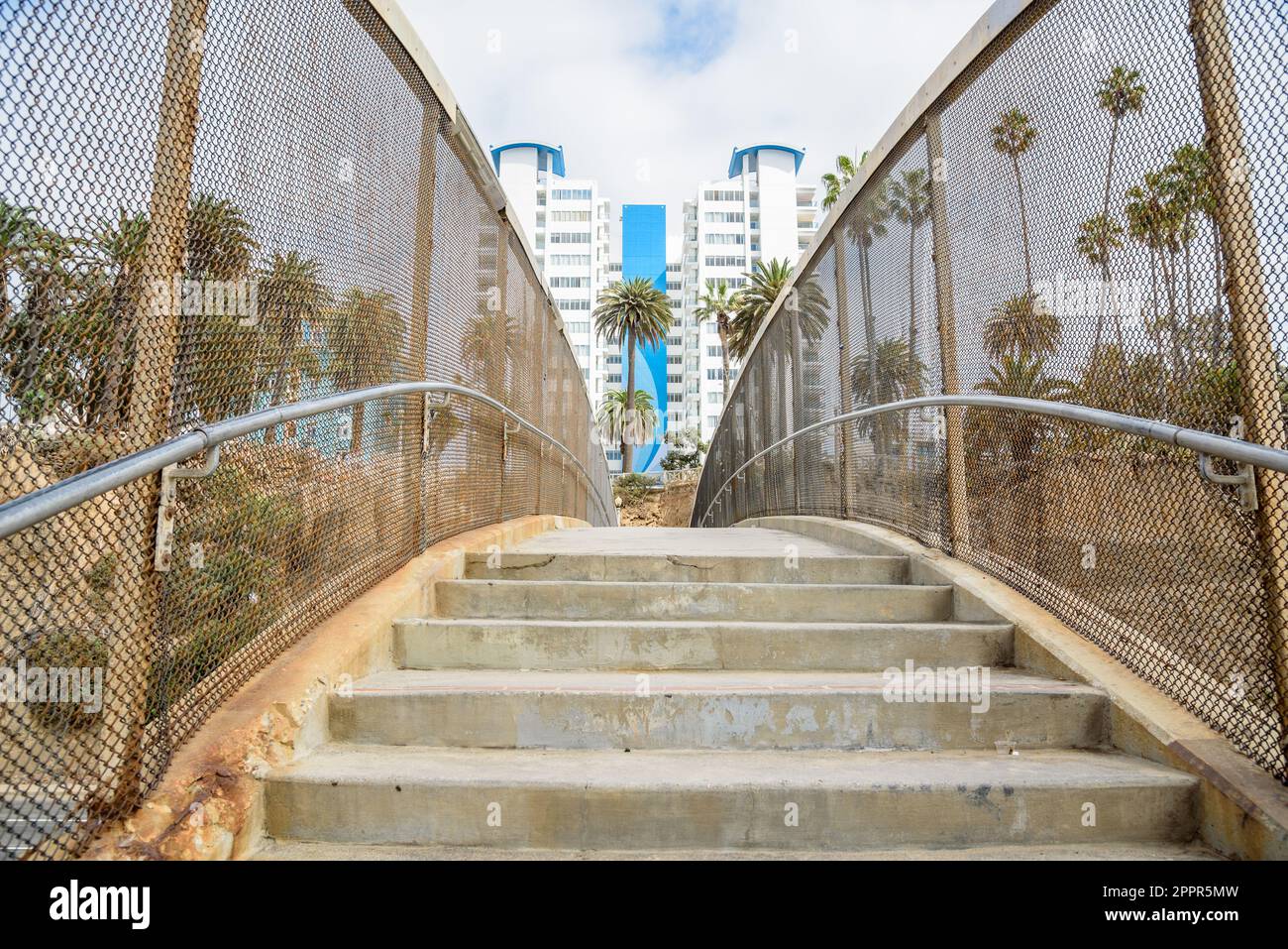 Steps to a narrow footbridge over a coast road Stock Photo - Alamy