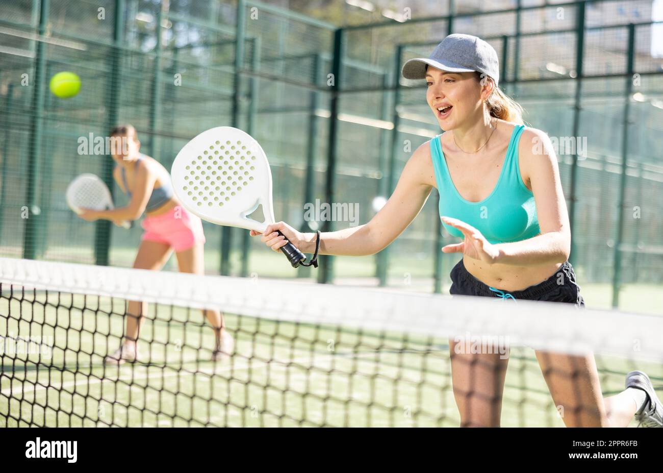 Young woman playing Padel Tennis in open-air tennis court Stock Photo ...