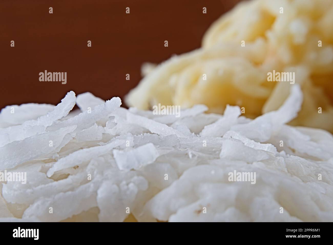 White and yellow cocada brown background seen very close ...