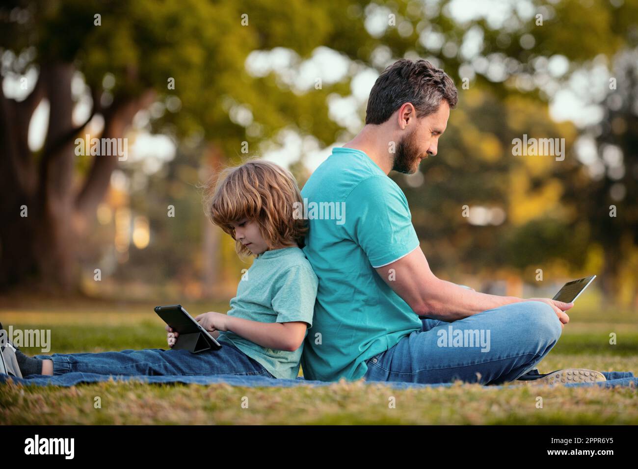 Kid with daddy learning lesson. Father and son use laptop, dad and ...