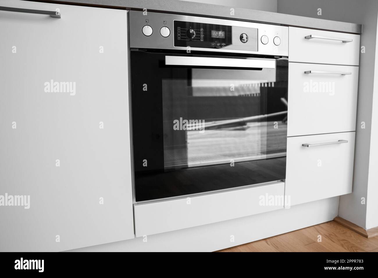Modern electric oven in light kitchen Stock Photo - Alamy