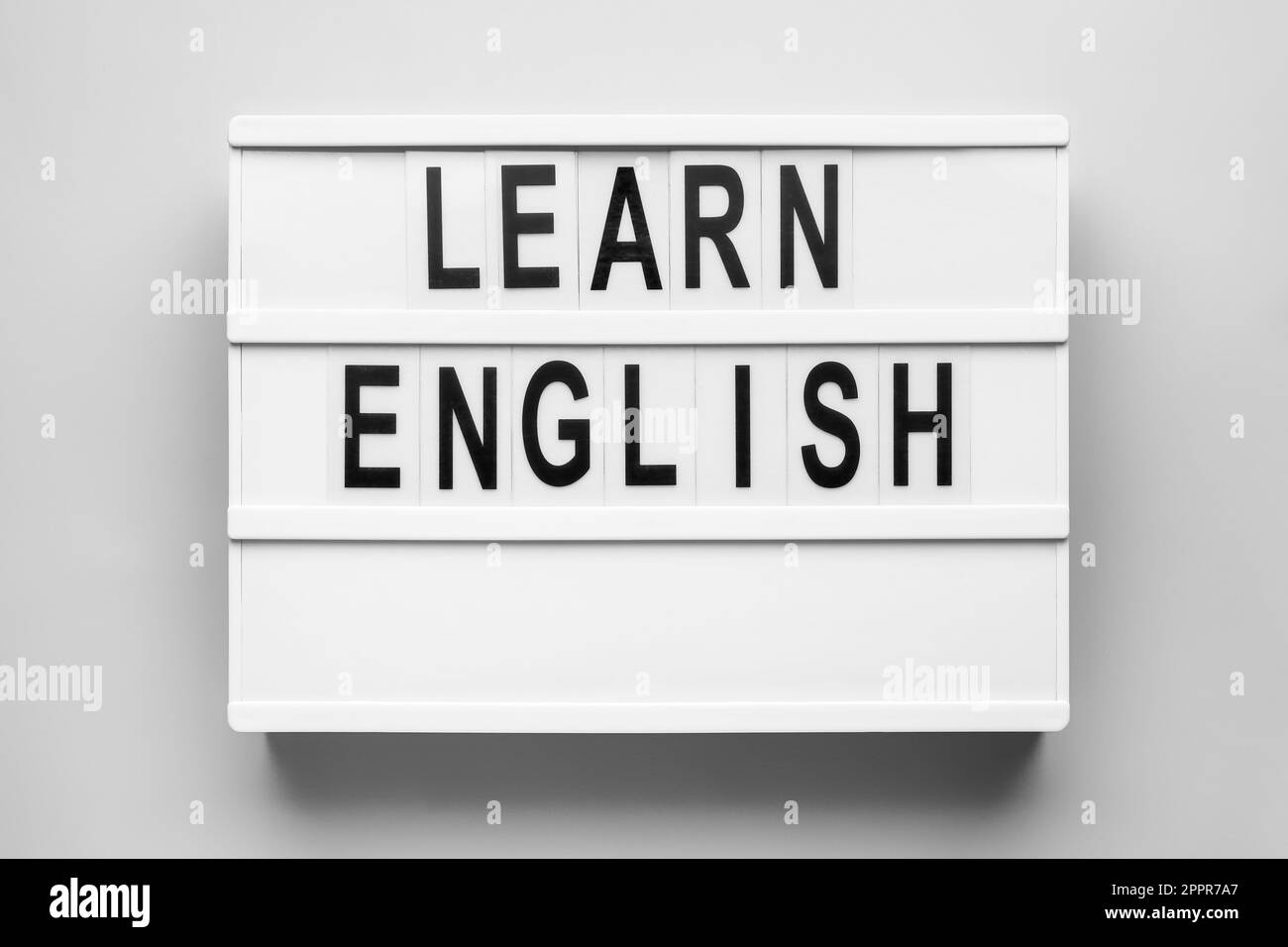 Board with text LEARN ENGLISH on light background Stock Photo - Alamy