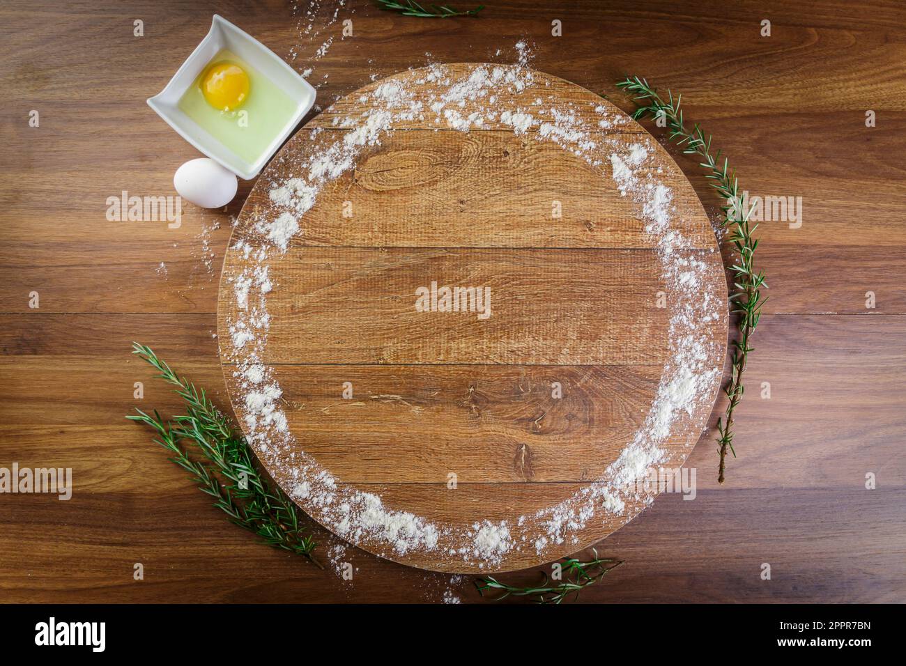 Wooden pizza pan, wrapped in wheat, eggs and rosemary. Top view Stock ...