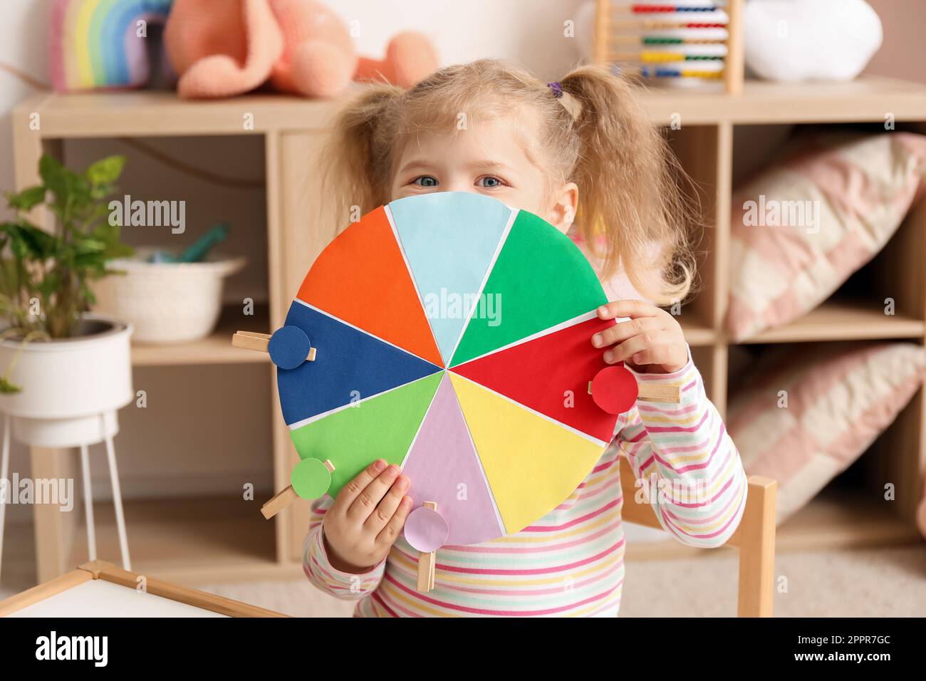 Cute little girl with matching game at home Stock Photo - Alamy
