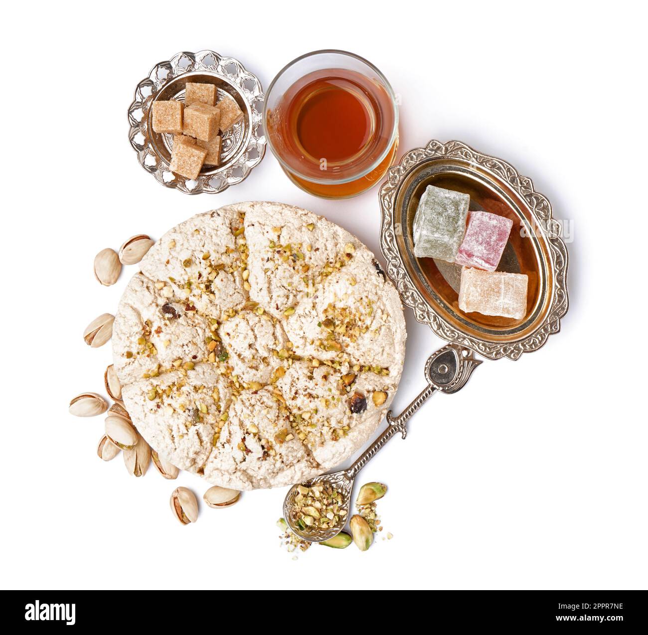 Tasty Tahini halva with pistachios, Turkish delight and glass of tea on ...
