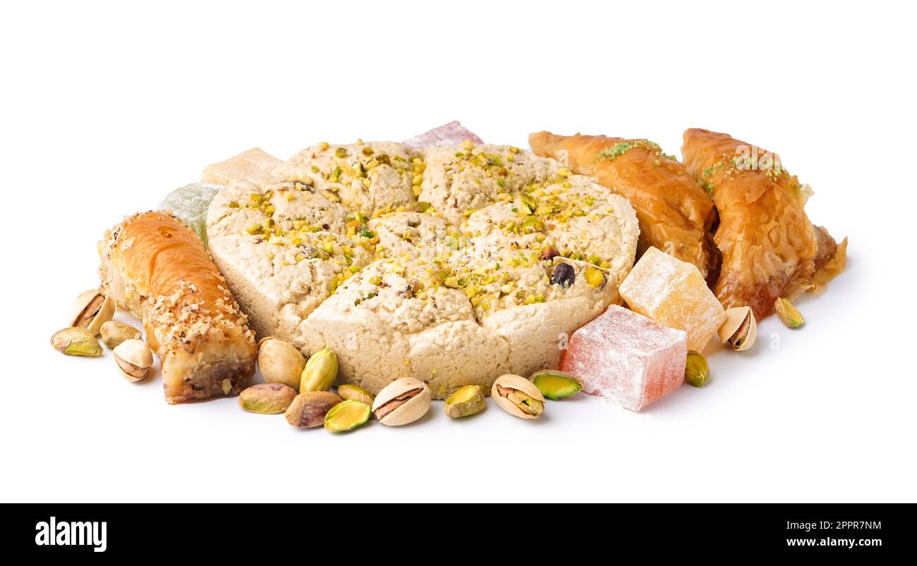 Tasty Tahini halva with pistachios, Turkish delight and baklava on ...